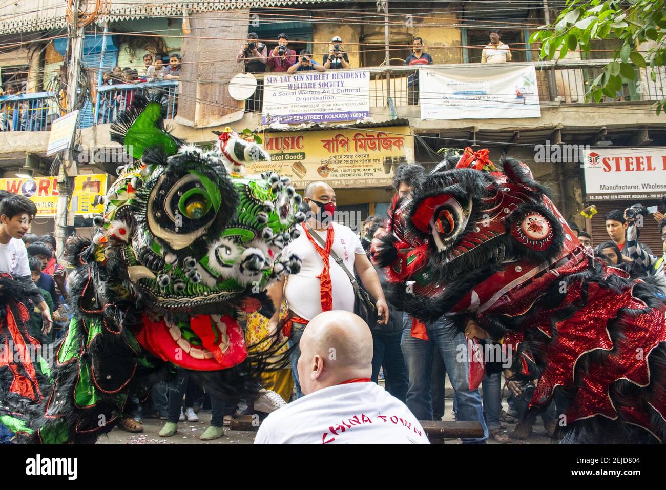 Chinese community members perform lion dance on street during the ...