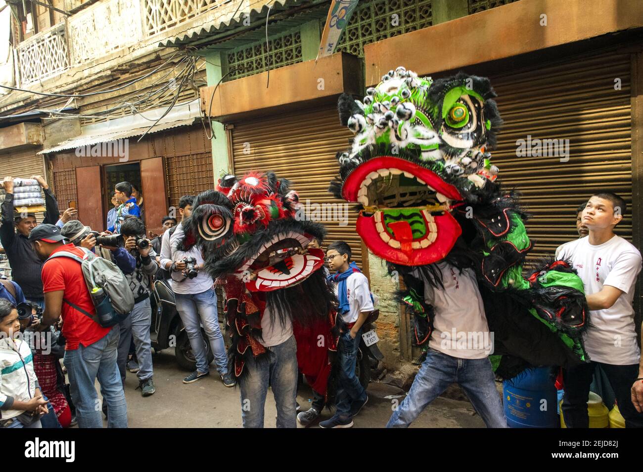 Chinese community members perform lion dance on street during the ...