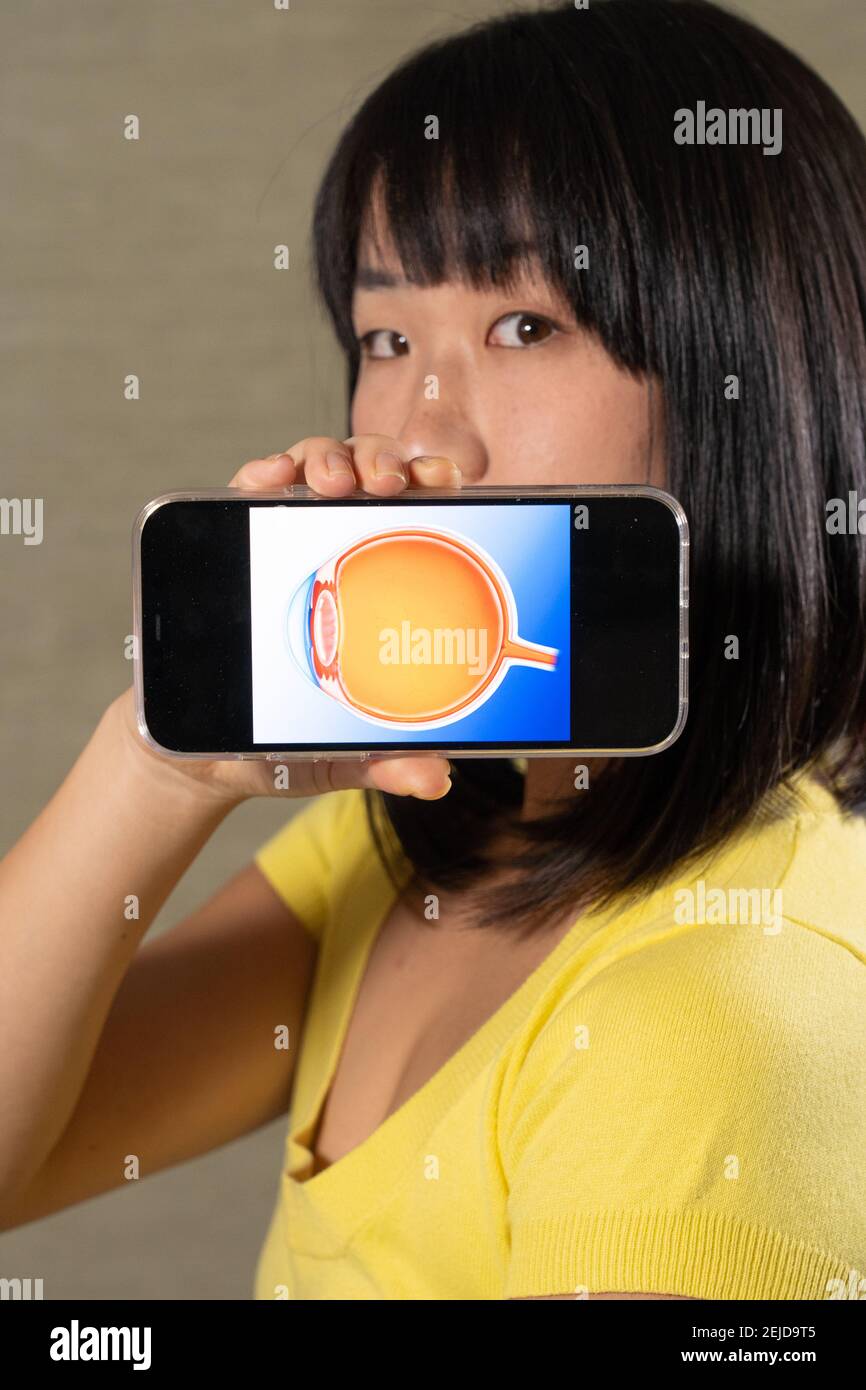 Woman holding screen with cut eye Stock Photo - Alamy
