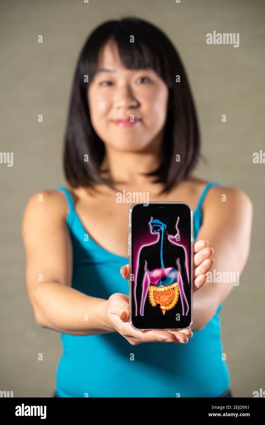 Woman holding screen with drawing of digestive system Stock Photo - Alamy
