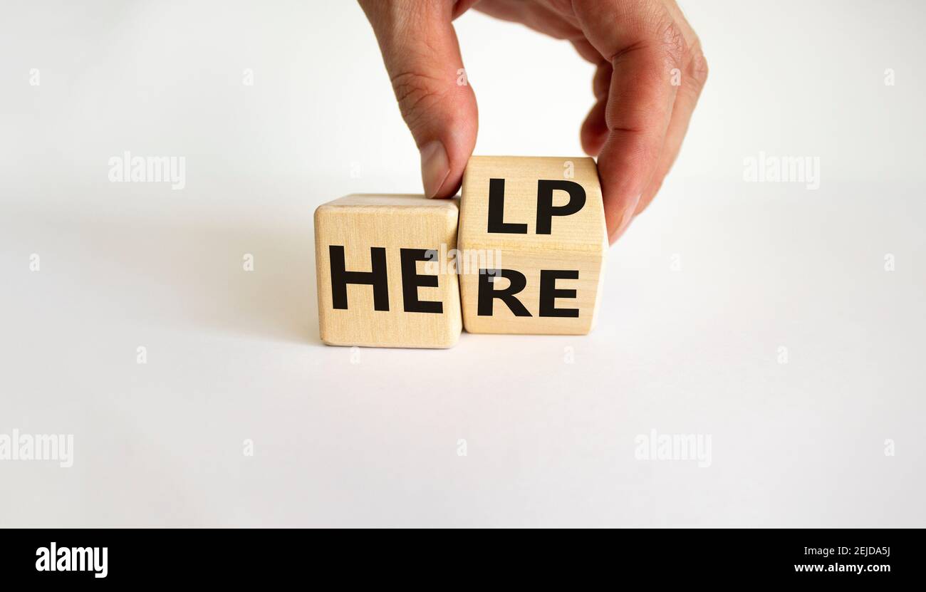 Help is here symbol. Businessman turns cubes and changes the word help ...