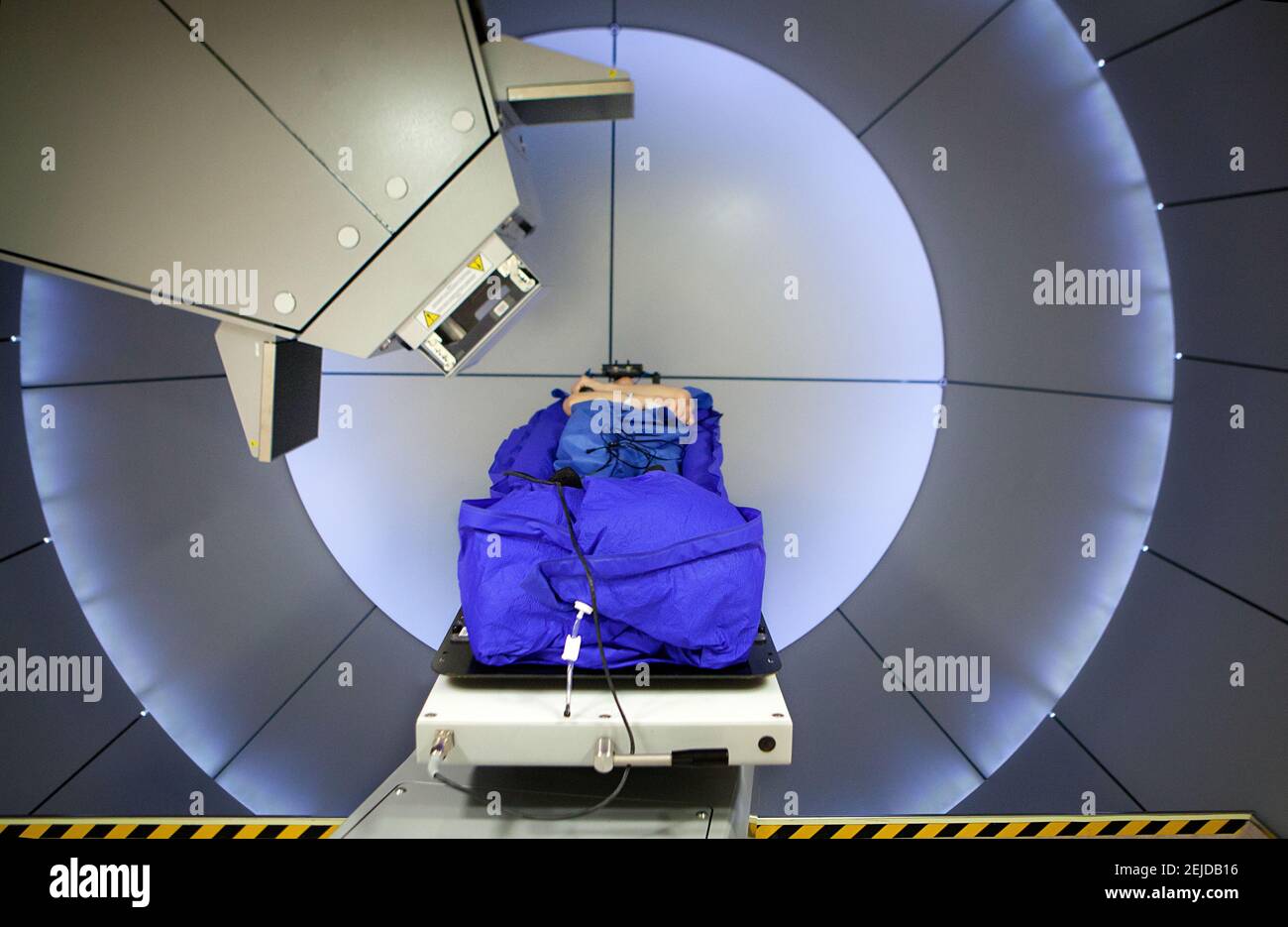 Proton therapy irradiates cancer cells with a beam of protons inside ...