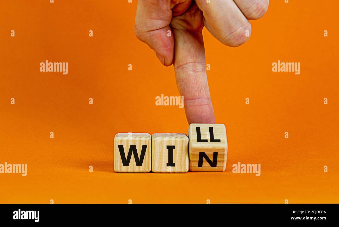 We will win symbol. Businessman turns cubes and changes the word will ...