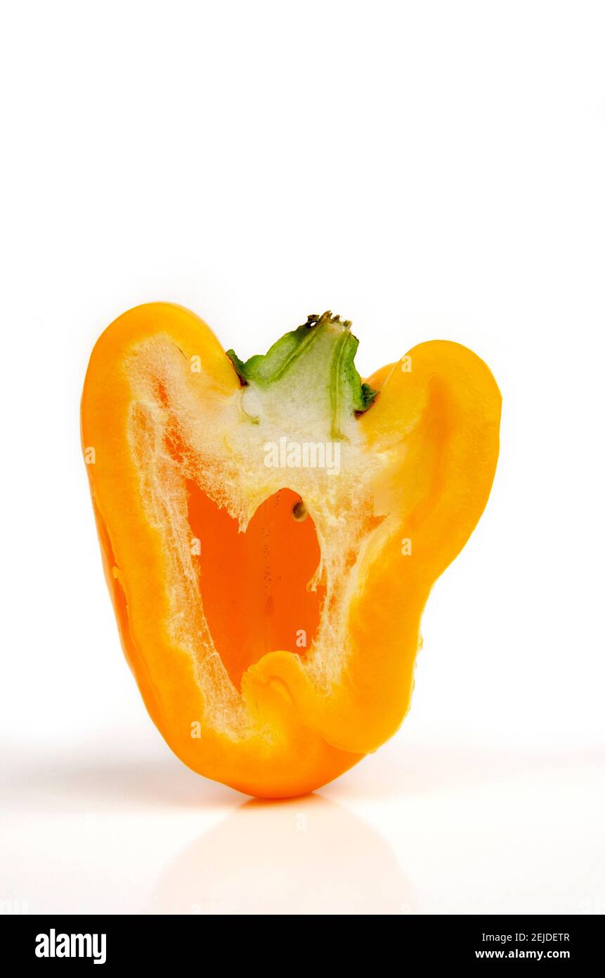 Bright yellow bell pepper cut in half showcasing vibrant colors and ...