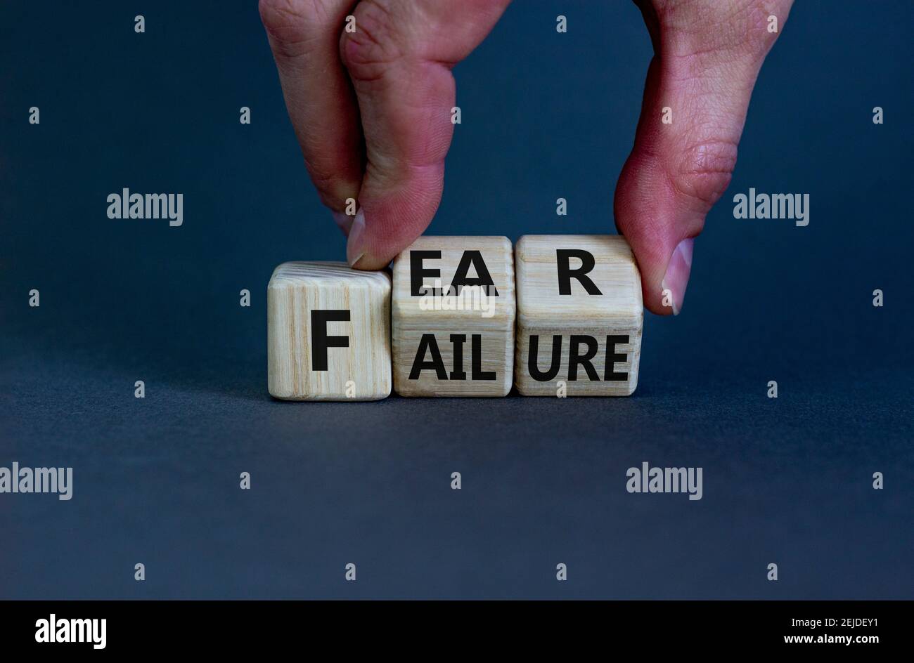 Fear of failure symbol. Businessman turns wooden cubes and changes the ...