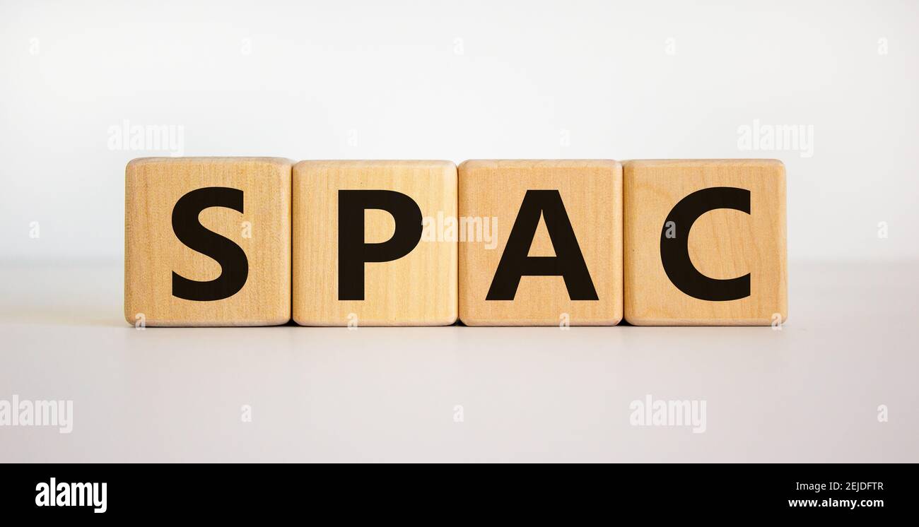 SPAC, special purpose acquisition company symbol. Wooden cubes with ...