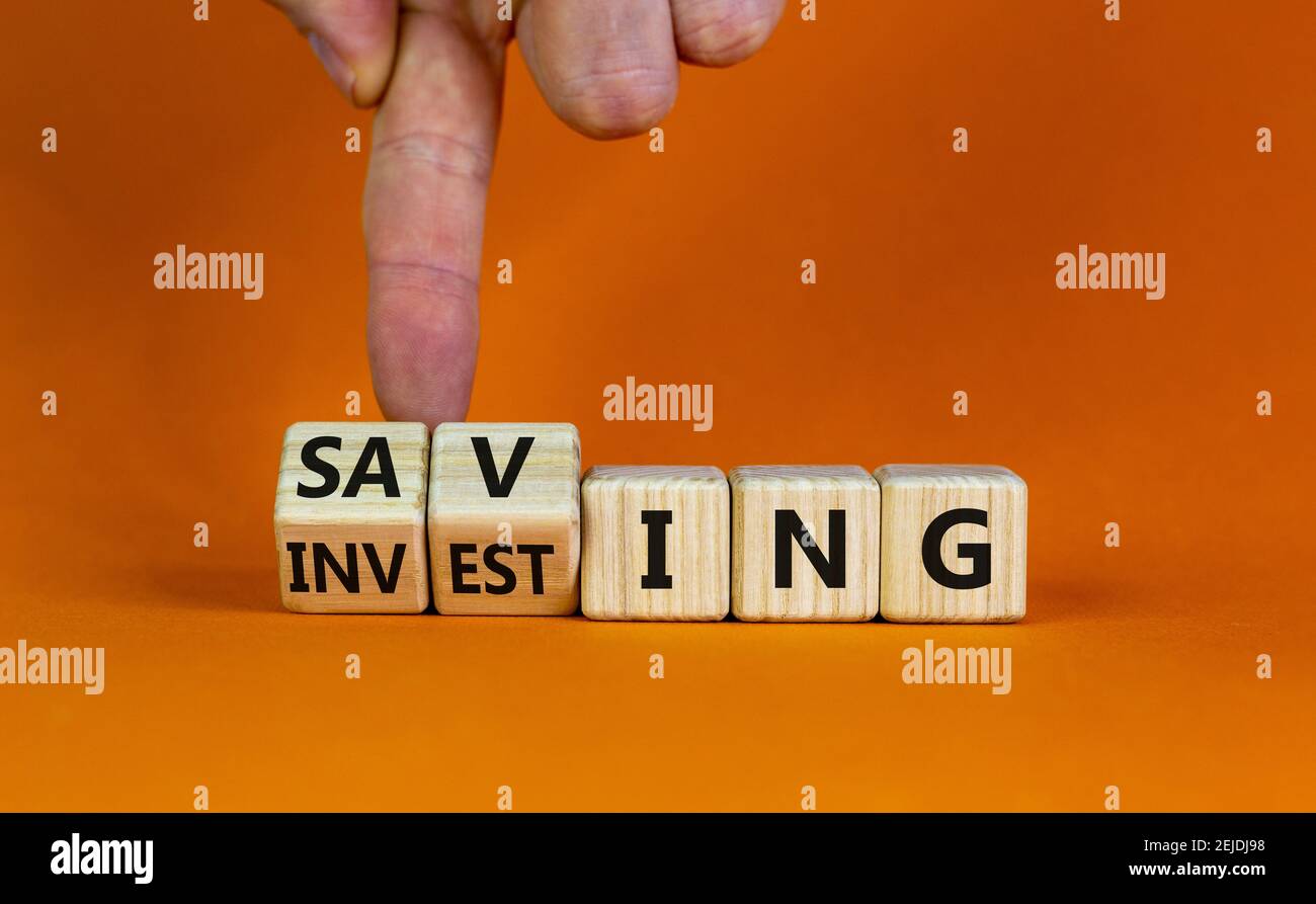 Saving or investing symbol. Businessman turns cubes and changes the ...