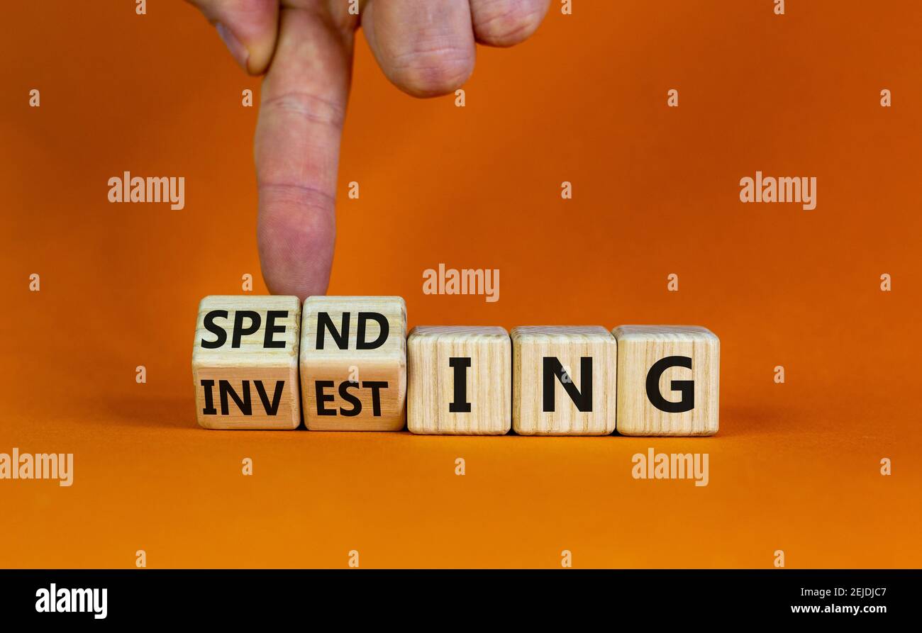 Spending or investing symbol. Businessman turns cubes and changes the ...