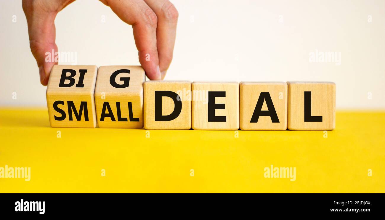 Big or small deal symbol. Businessman turns a wooden cube and changes ...