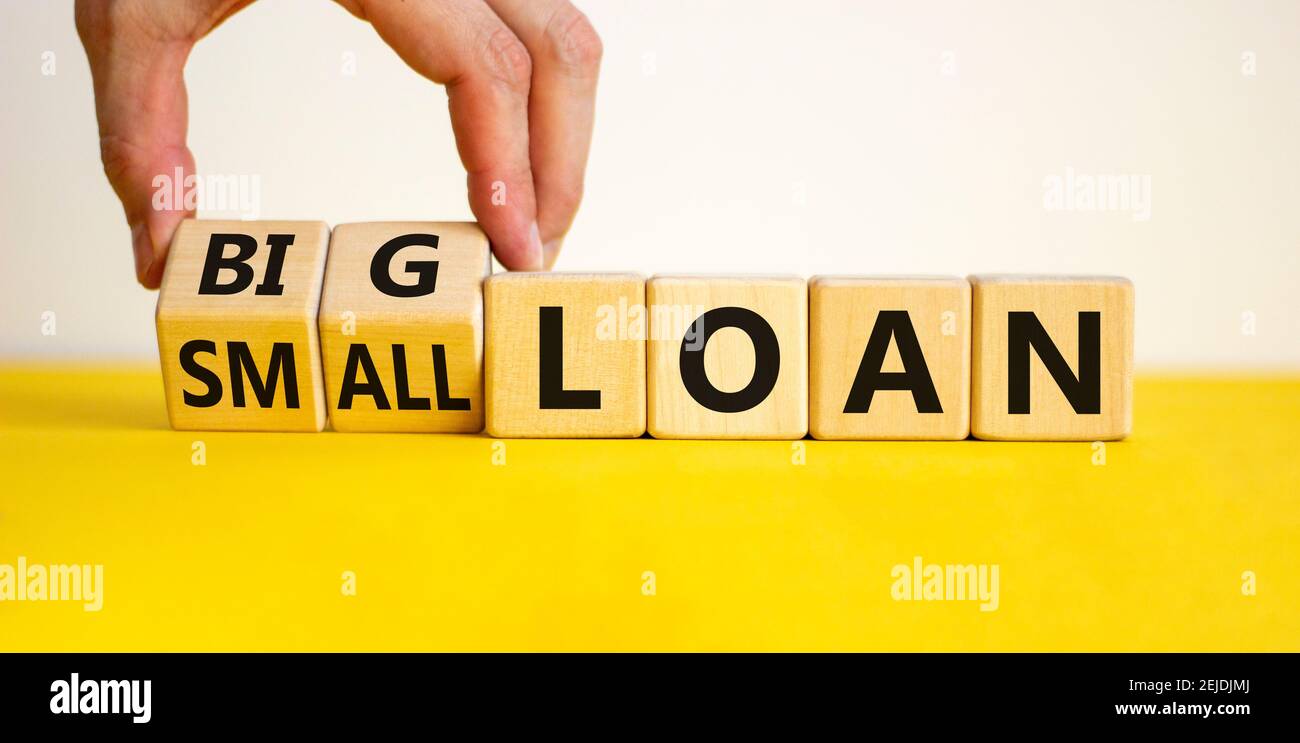 Big or small loan symbol. Businessman turns a wooden cube and changes ...