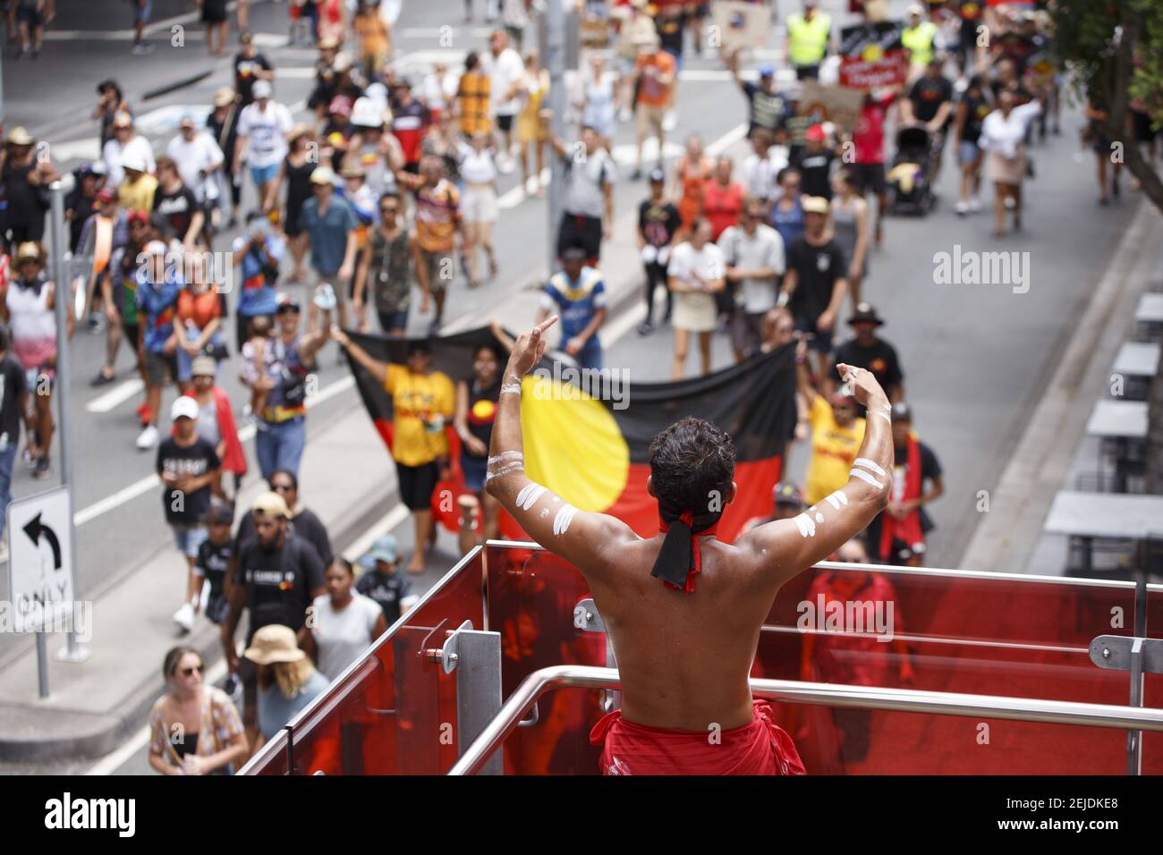 An indigenous protester applauds the crowd as they march towards ...