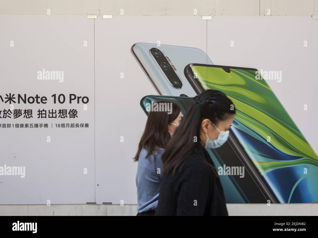 Commuters pass by Xiaomi Note 10 Pro smartphone advertisement at its ...