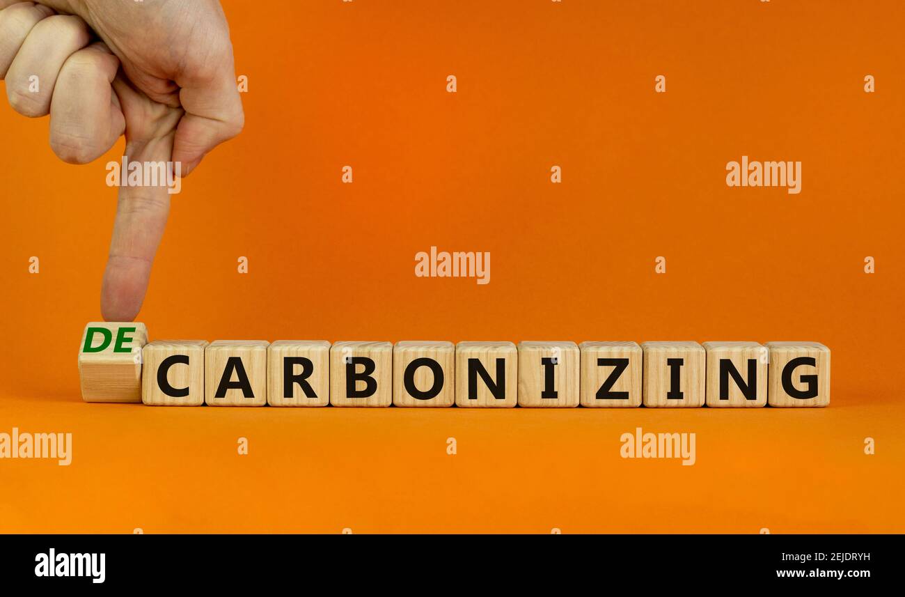 Carbonizing or decarbonizing symbol. Businessman turns wooden cube and ...