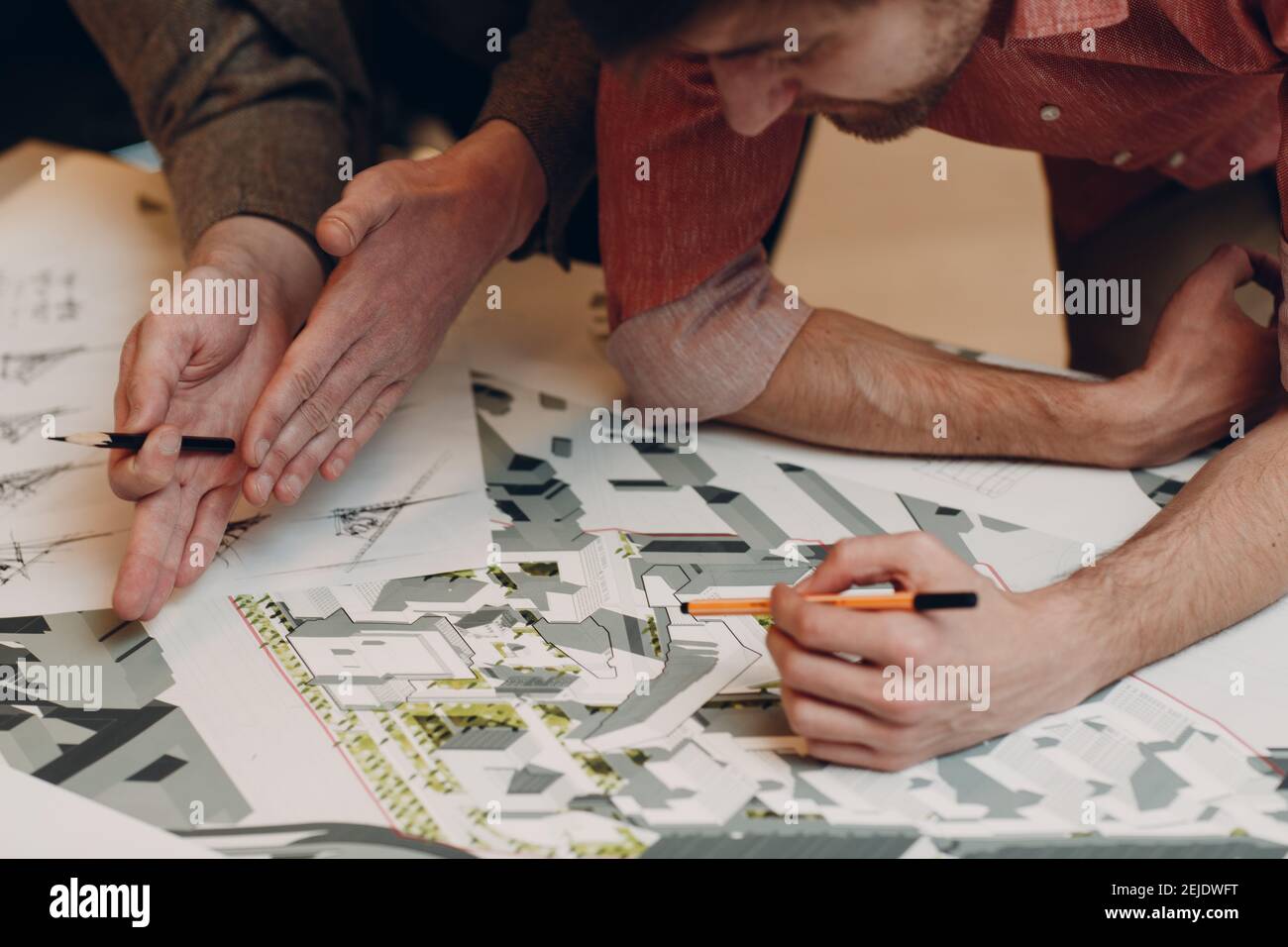 Architect with blueprints and layout design project at office bureau ...