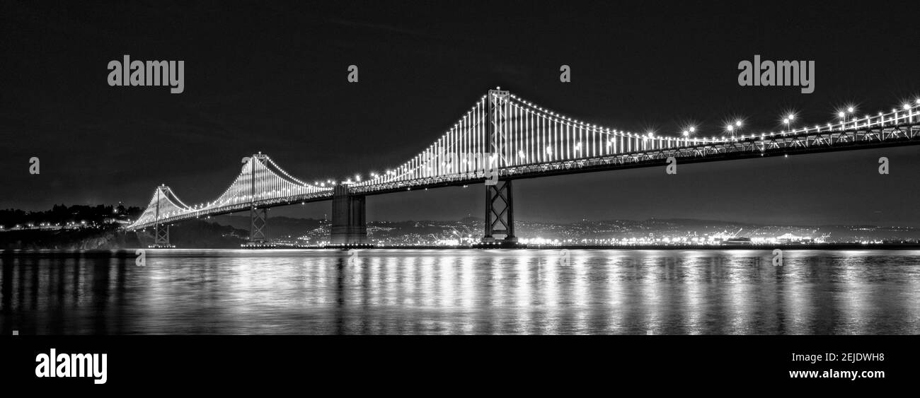 Suspension bridge over Pacific ocean lit up at night, Bay Bridge, San ...