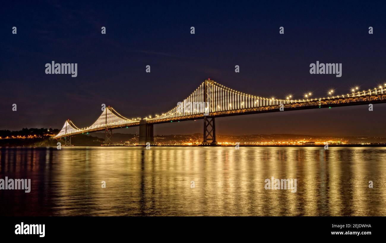 Suspension bridge over Pacific ocean lit up at night, Bay Bridge, San ...