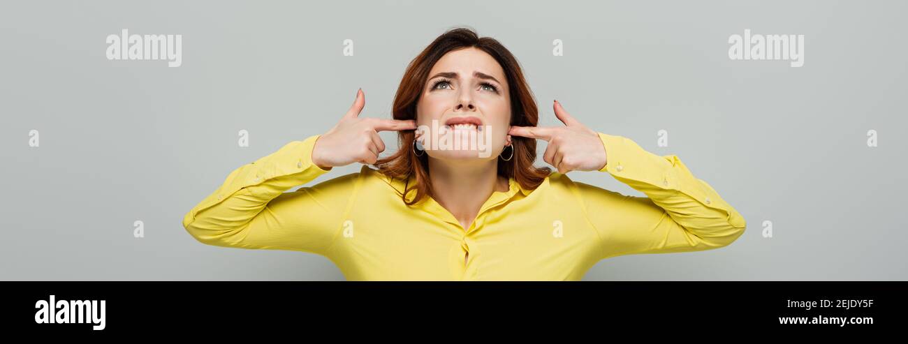 Woman plugging ears hi-res stock photography and images - Alamy