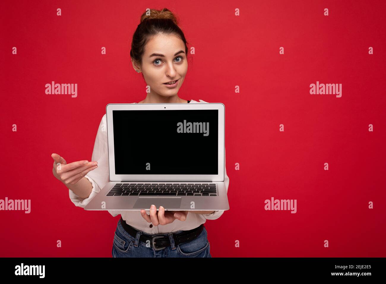 Close-up portrait of Beautiful smiling happy young woman holding ...