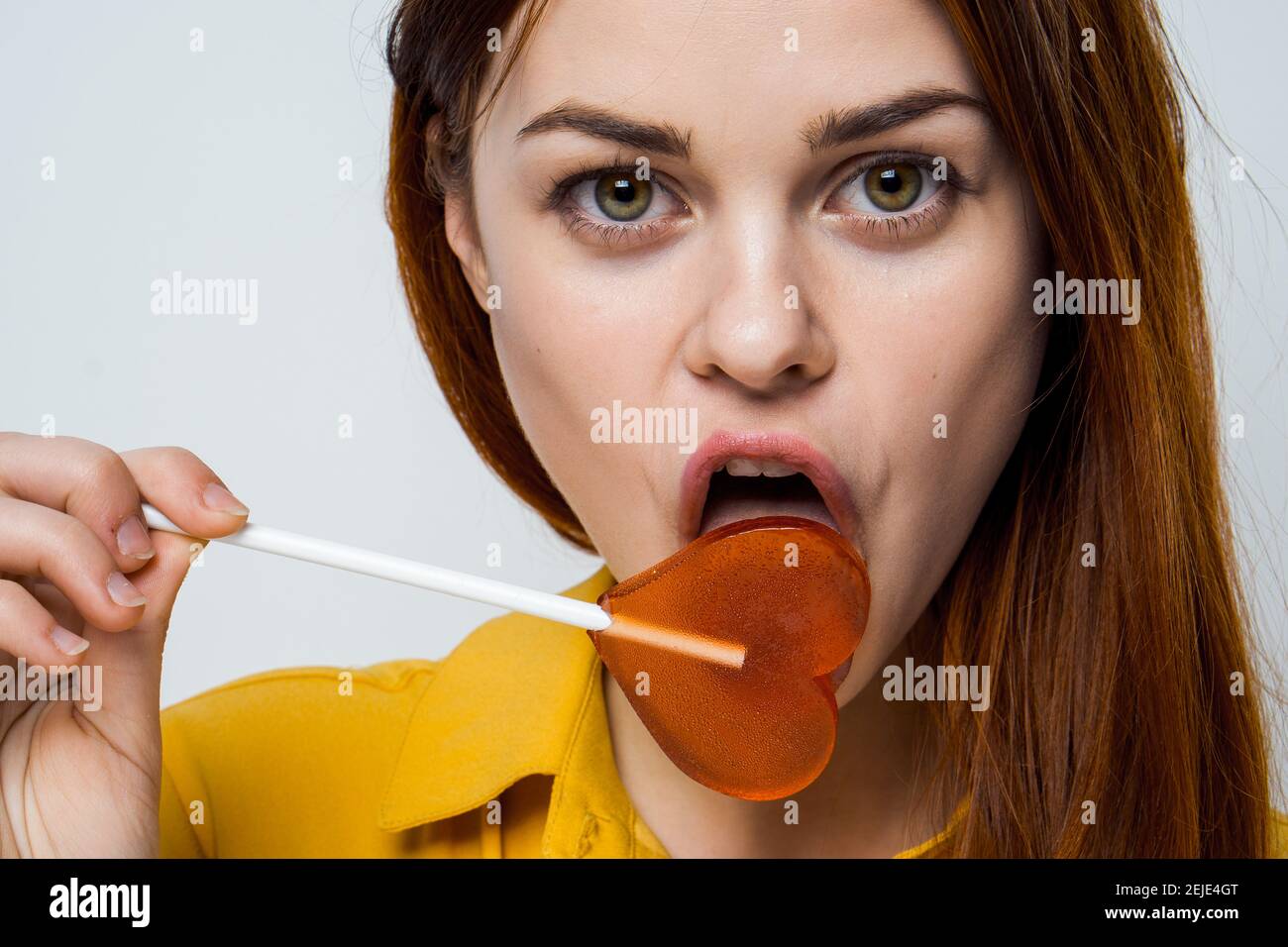 Pretty woman licking heart hi-res stock photography and images - Alamy