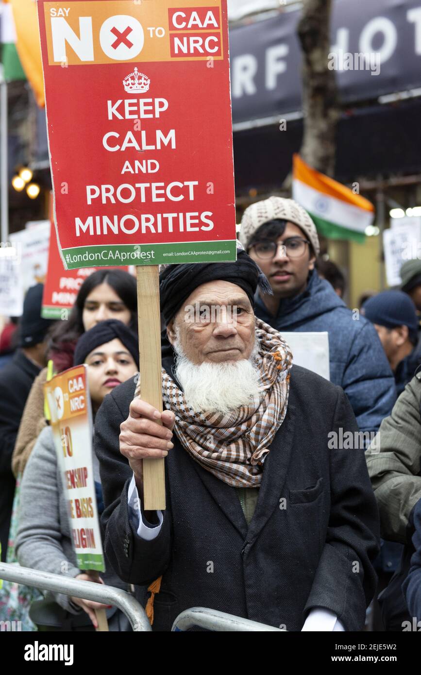 A protester holds a placard during the demonstration. People gather ...