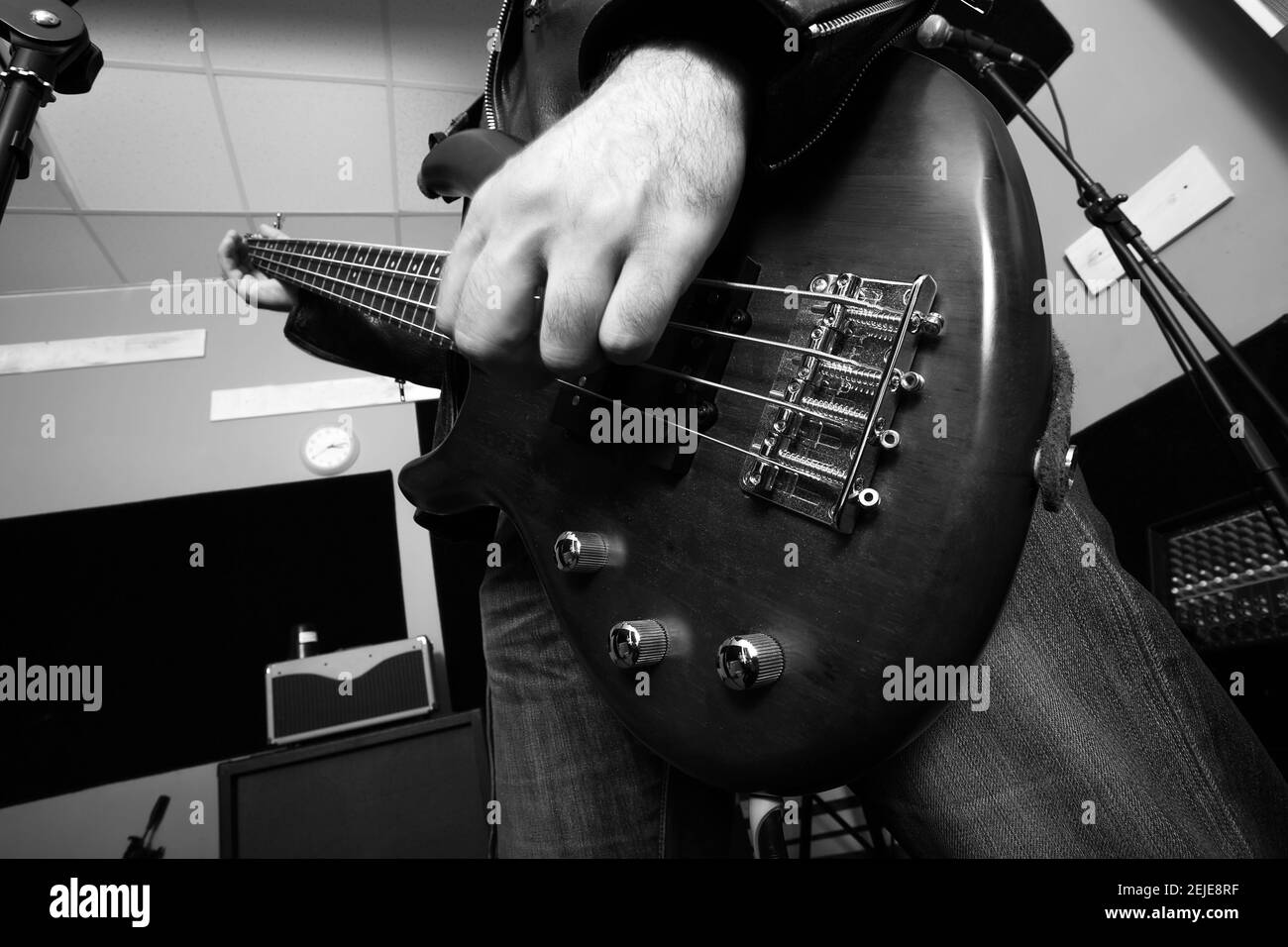 A Rock musician playing passionately bass in the rehearsal Studio Stock ...