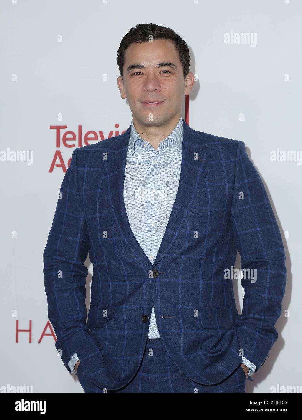 Conrad Ricamora walking the red carpet at the Television Academy's 25th ...