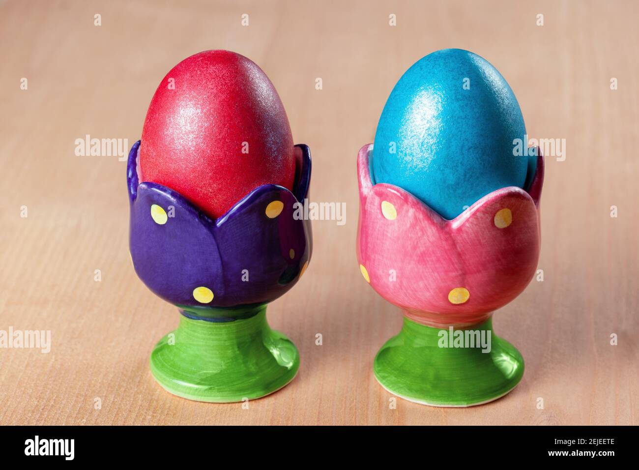 Colored easter eggs in egg cups Stock Photo - Alamy