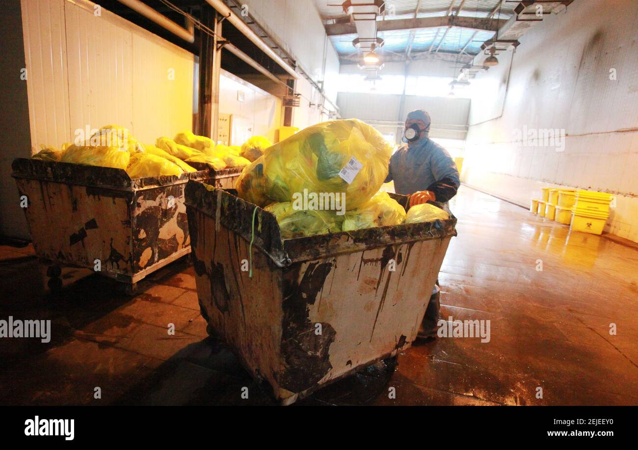 A Chinese worker carts medical wastes to be disposed at a disposal ...