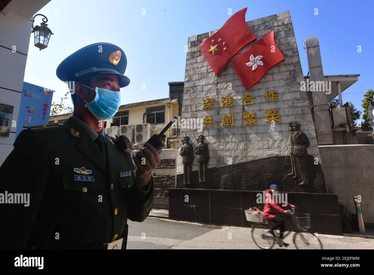 A Chinese paramilitary policeman wearing a face mask for prevention of ...