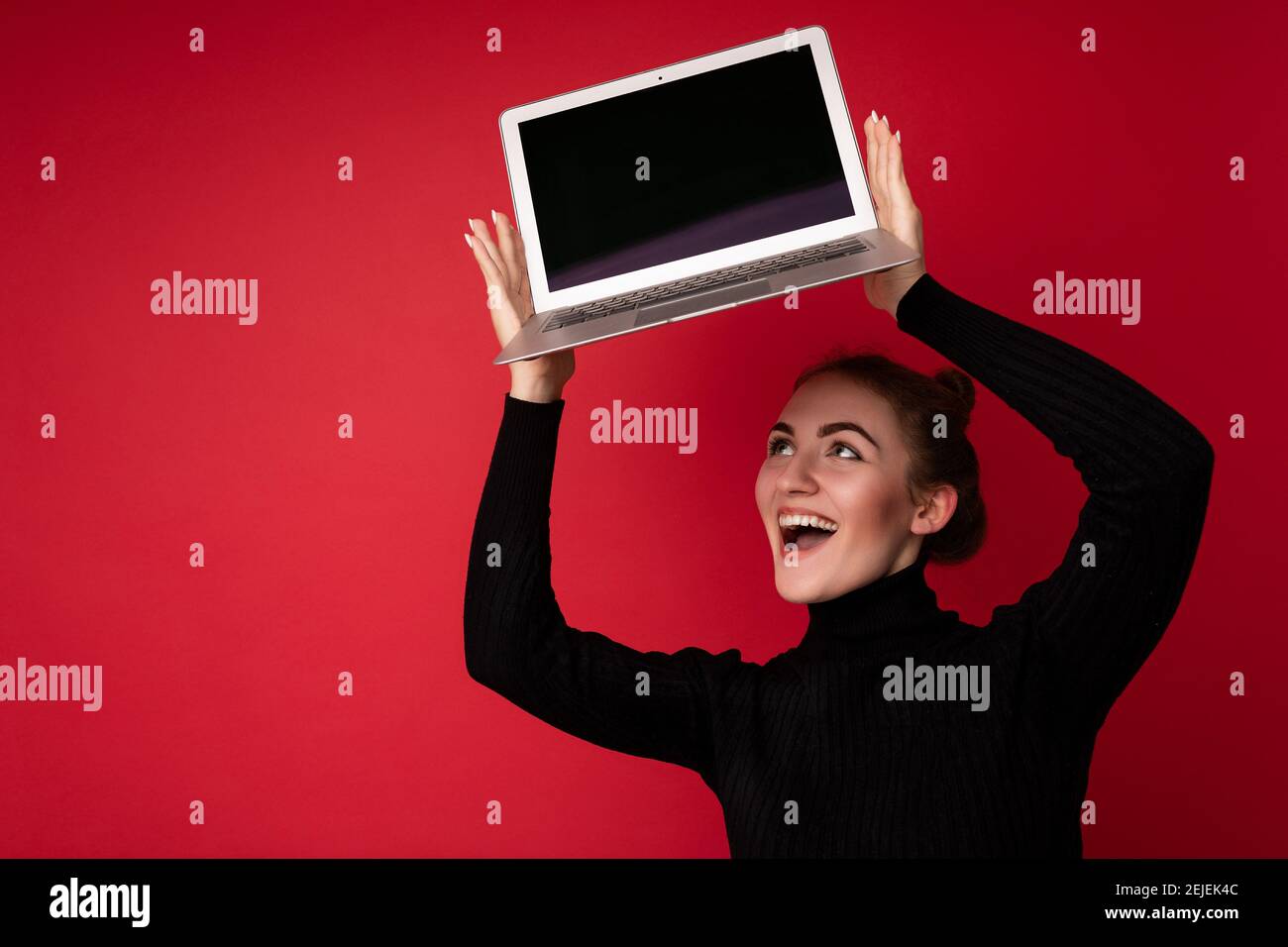 Photo of Beautiful smiling happy young brunette woman holding computer ...
