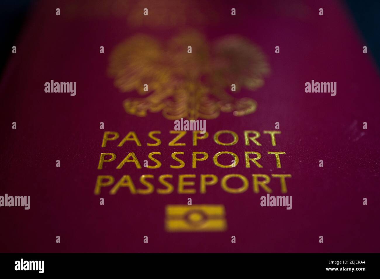 In this photo illustration a burgundy red biometric Polish passport ...