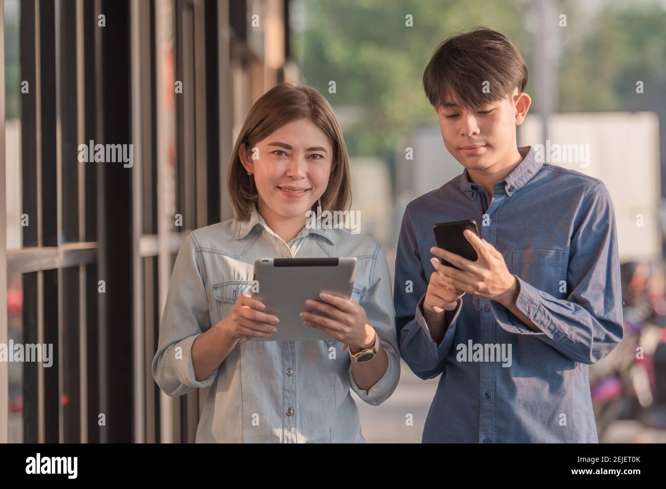People using tablet and smartphone talking business Stock Photo - Alamy