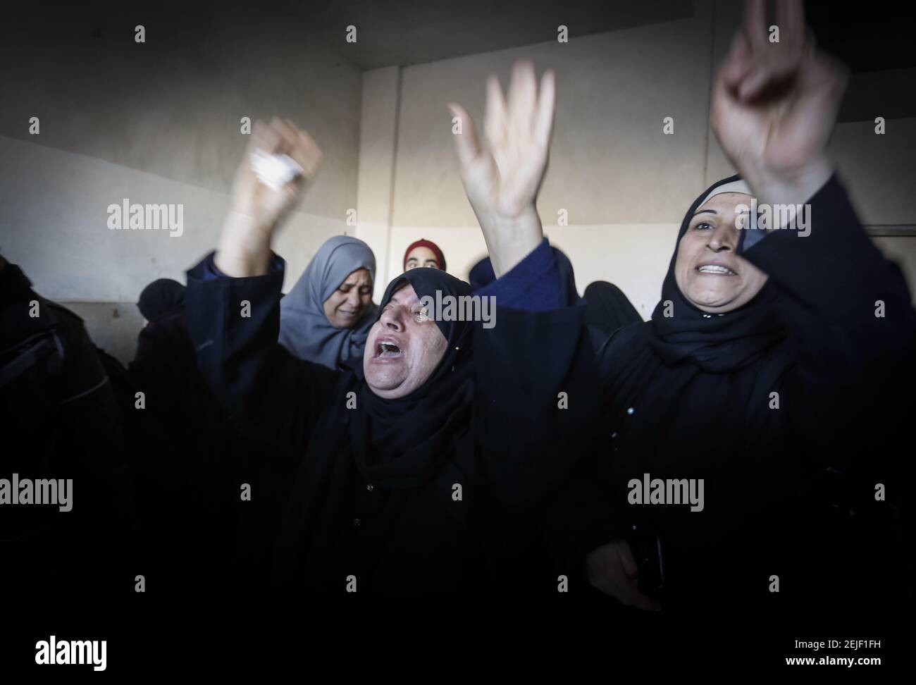 Relatives to the deceased mourn during the funeral. Palestinian boy ...