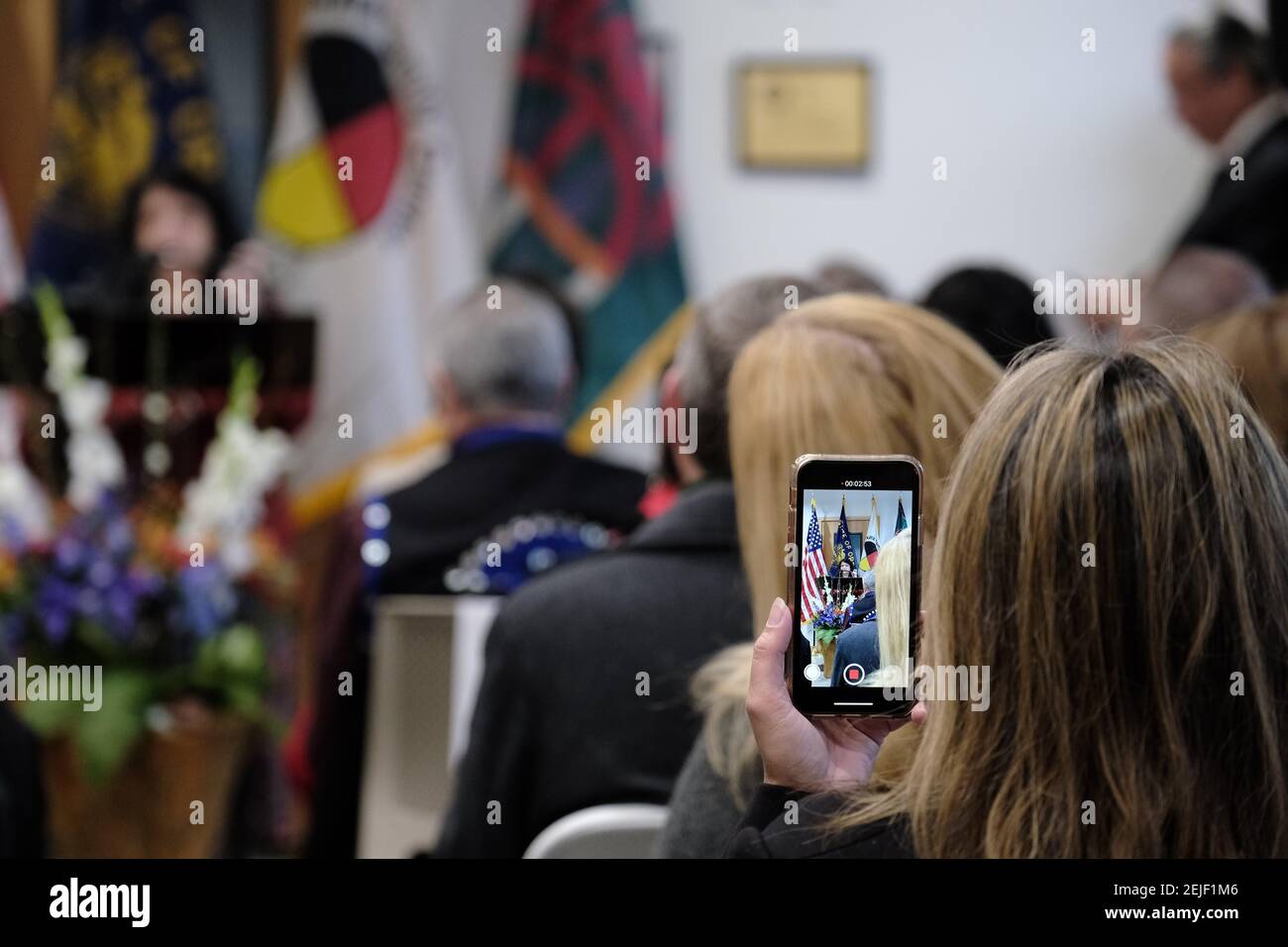 A woman takes a picture as Jackie Mercer, CEO of the Native American ...