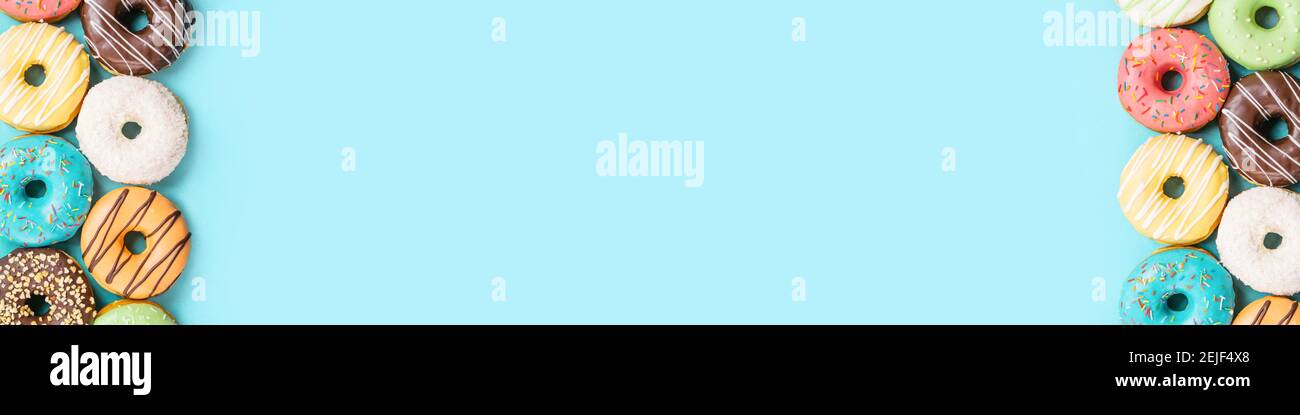 Long horizontal banner with assorted donuts on blue background ...