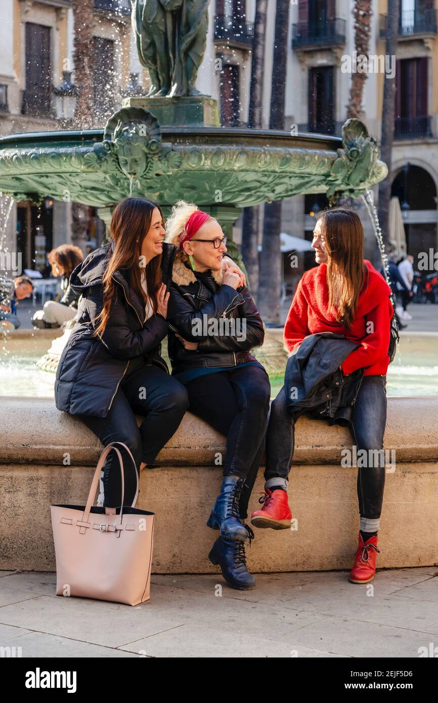 Authentic mixed generations women have fun together outdoor, talking ...