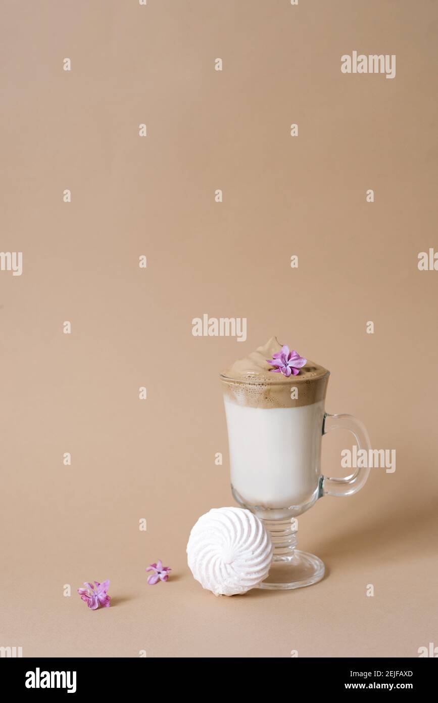 Beautiful dalgon coffee drink with foam in a transparent Cup and ...