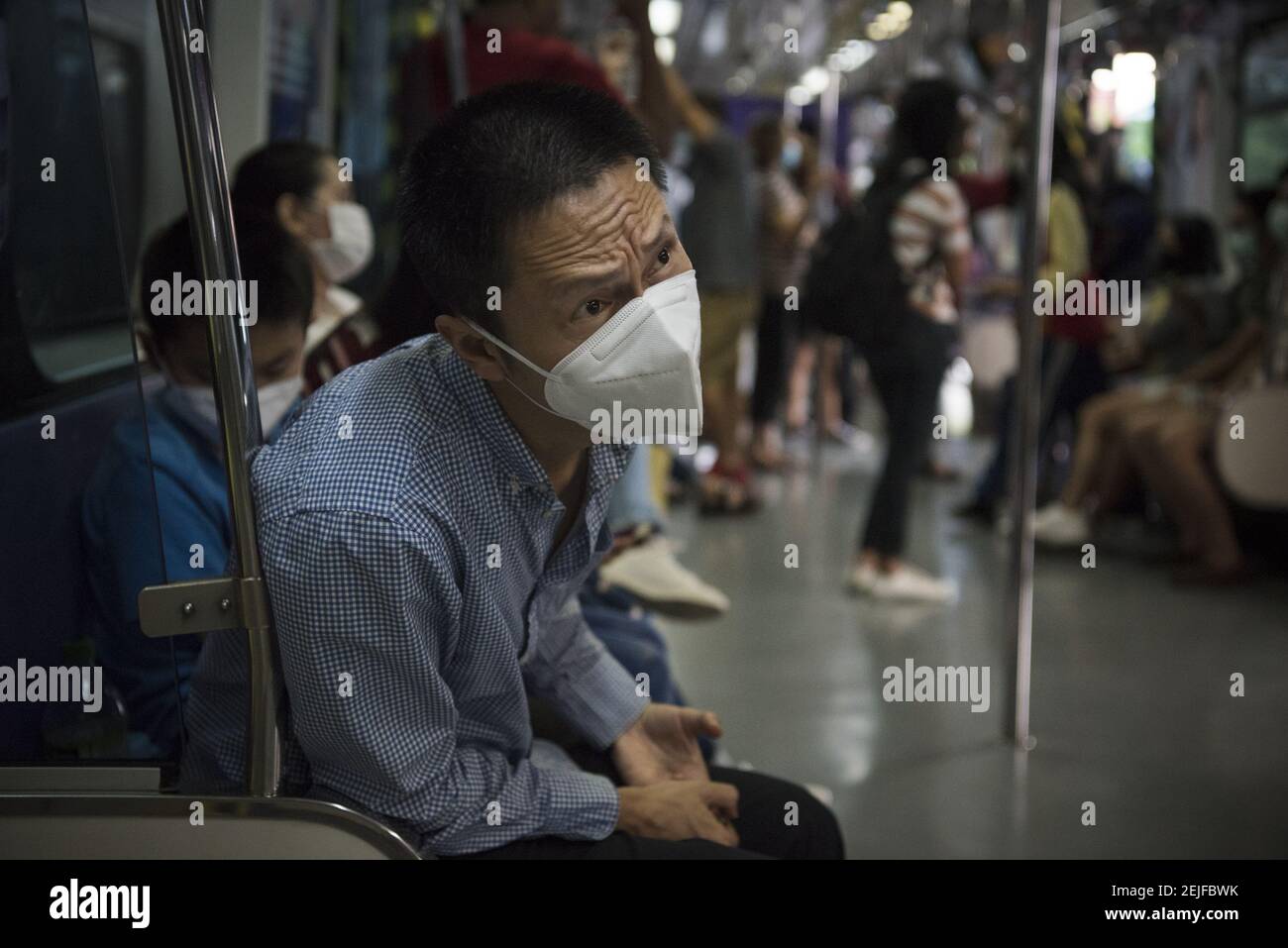 A man wearing a face-mask on a train following the virus outbreak. Fear ...