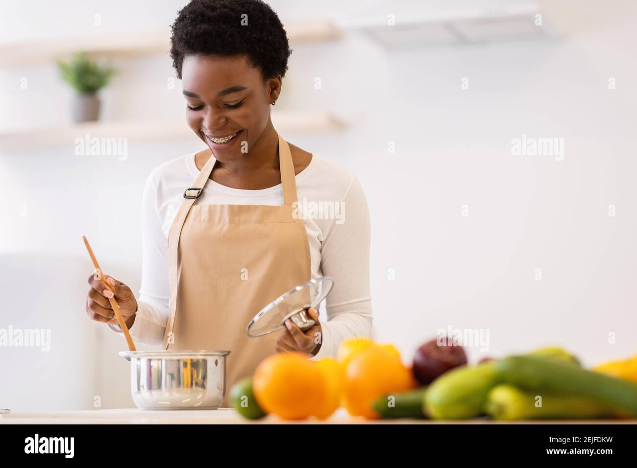 African Woman Cooking Dinner Standing In Modern Kitchen At Home Stock ...