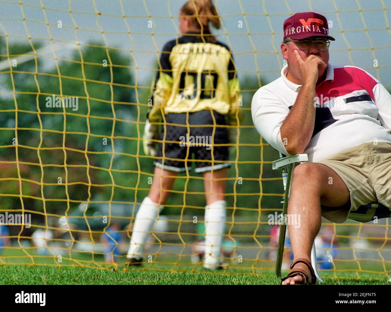 Spectator turns his back on a youth soccer game in Virginia Stock Photo ...