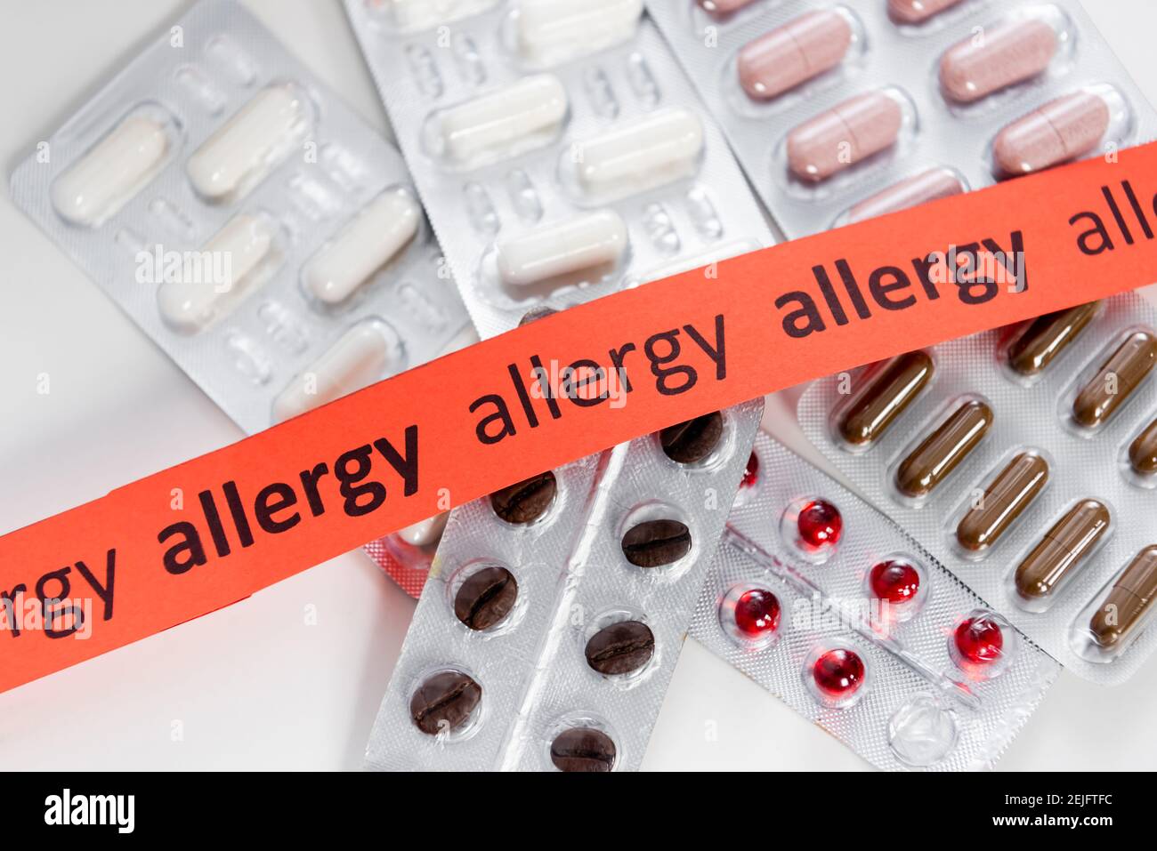 Top view of ribbon with allergy lettering near pills on table Stock ...