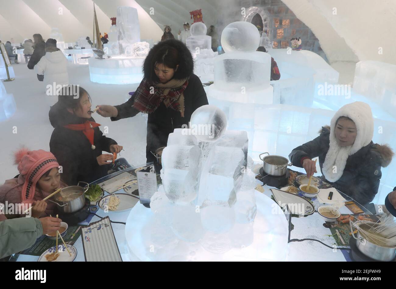 Customers eat hot pot with families and friends in an ice-made hut ...