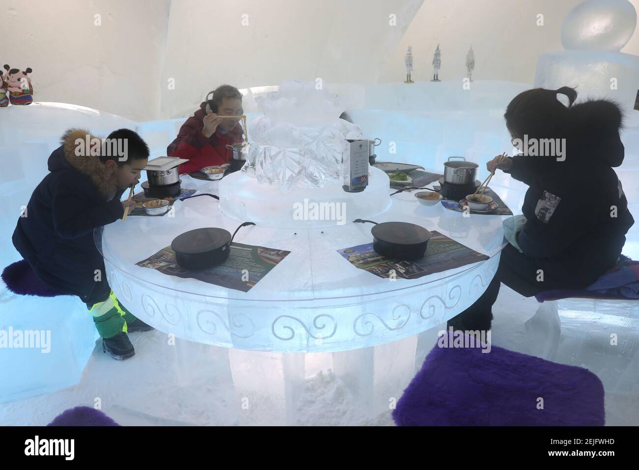 Customers eat hot pot with families and friends in an ice-made hut ...