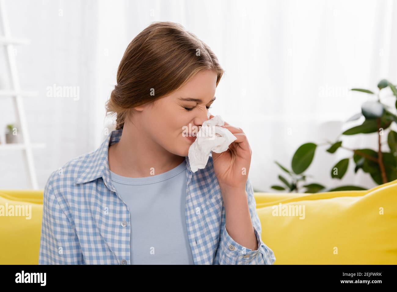 Young woman with napkin having snuffle during allergy Stock Photo - Alamy