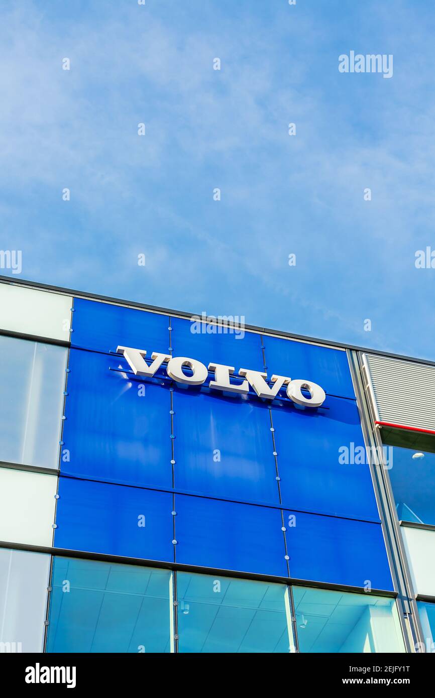 Volvo brand logo on bright blue sky background located on its sale ...