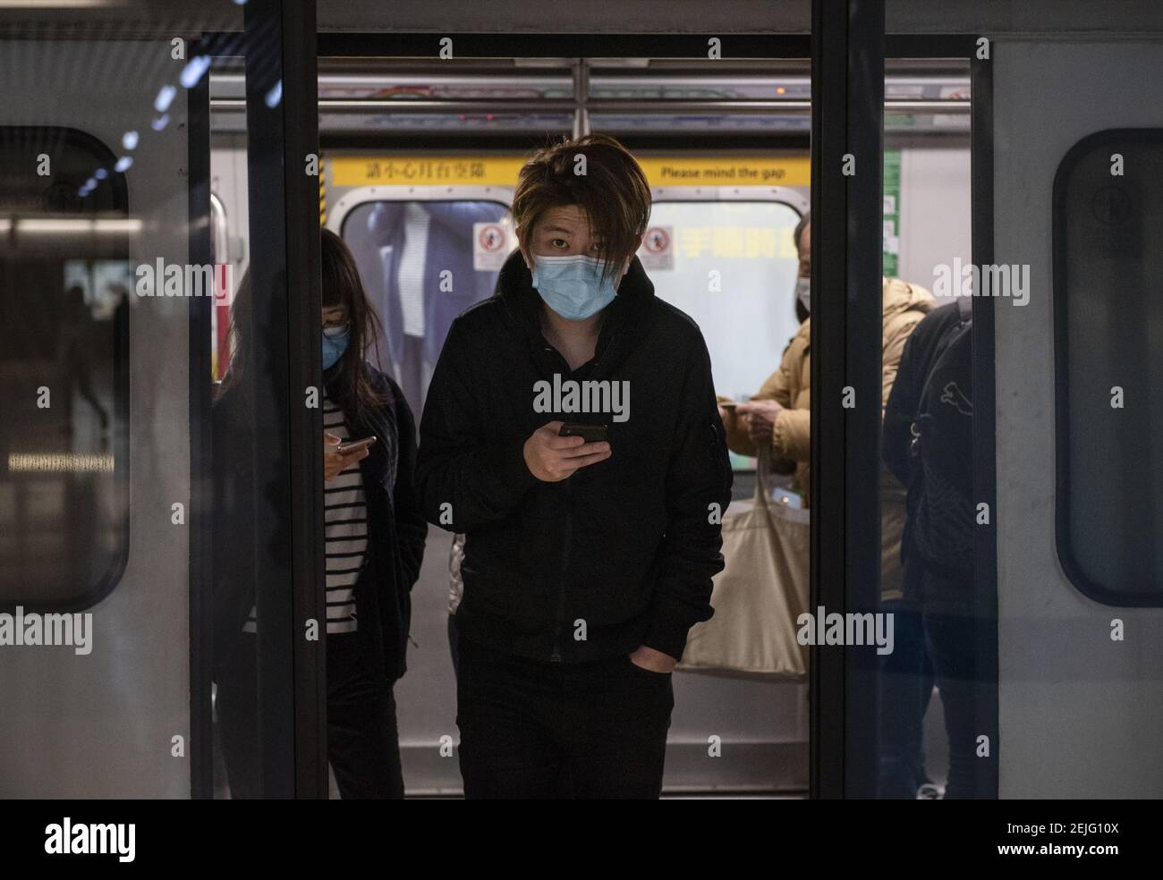 Commuters wearing face masks exit MTR subway train in Admiralty station ...