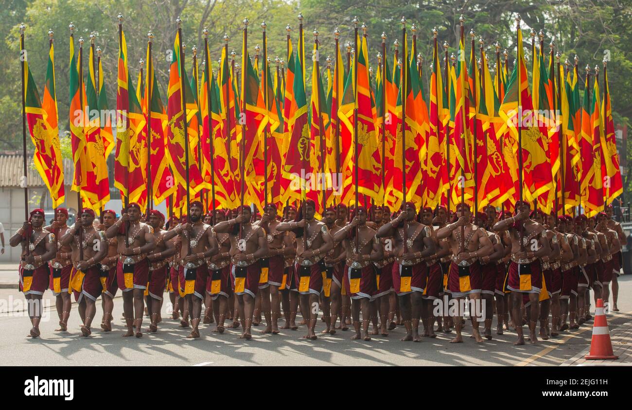 Sri Lankan Army soldiers carry Sri Lankan national flags dressed in ...