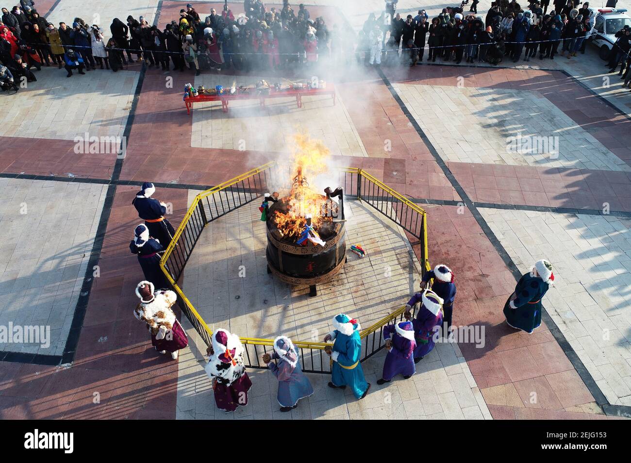 An aerial view of crowd surrounding a bonfire at a ceremony to ...
