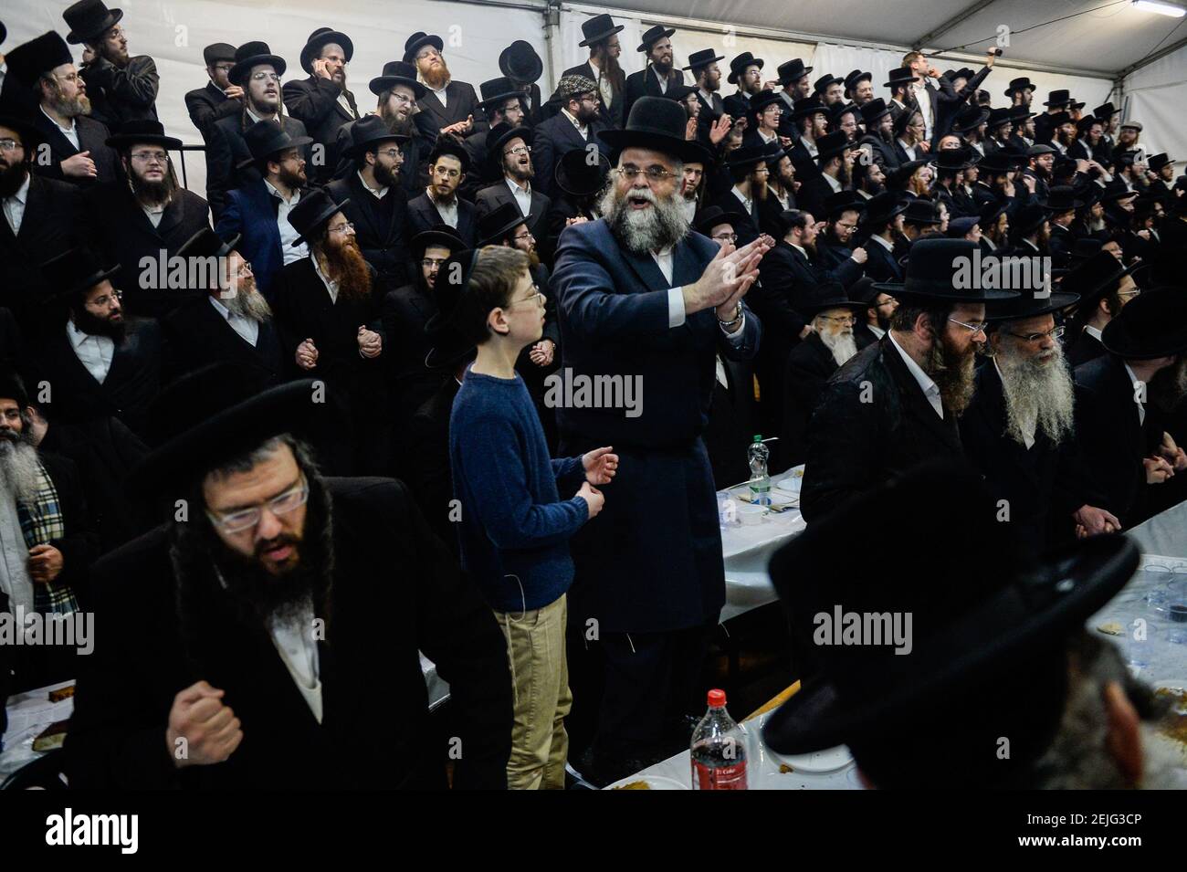 An elderly Hasidic Jew claps hands as he dances during the celebration ...