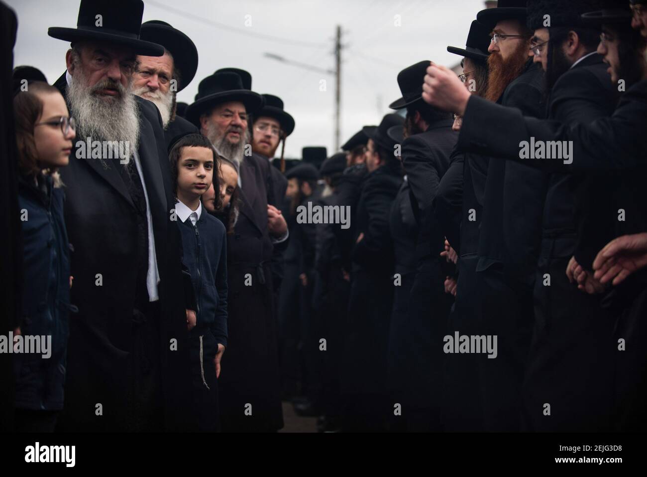 Hasidic Jews stand together next to a bonfire during the celebration ...